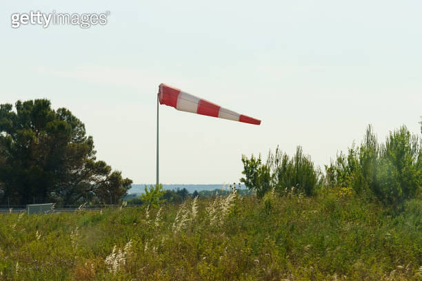 A red and white wind cone indicating the direction and strength of the ...