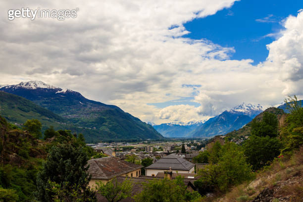 Panoramic view from a hill over City of Sion with and Swiss Alps in ...