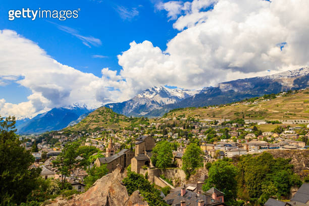Panoramic view from a hill over City of Sion with and Swiss Alps in ...