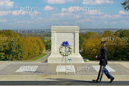 A lone soldier stands guard over the Tomb of the Unknown Soldier at ...