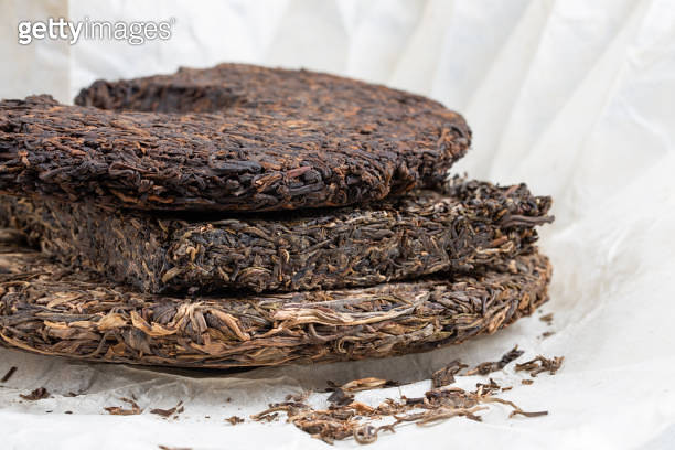 Stack of three different flat disc of puer tea. Pressed Chinese ...