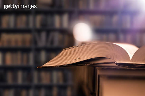Learning from books in the library. Open book in college library ...