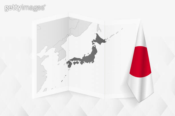 A grayscale map of Japan with a hanging Japanese flag on one side ...