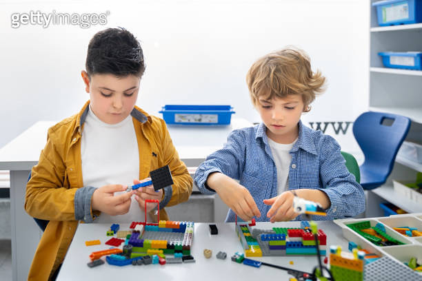 Robotics programming class. Children construct and code Robot. STEM ...