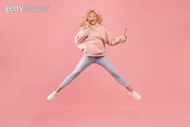 Wow offer. Full length portrait of surprised lady jumping, staring at ...