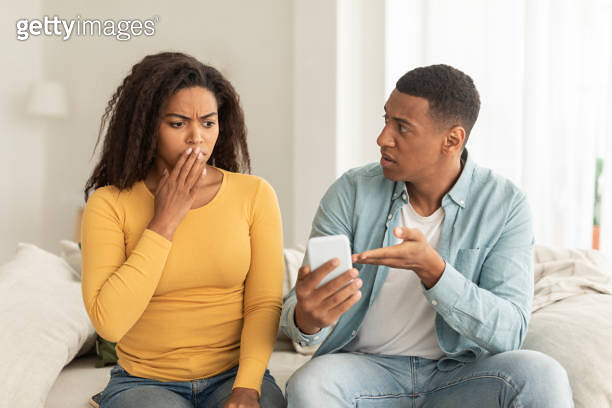Sad Millennial African American Husband With Smartphone Scolding