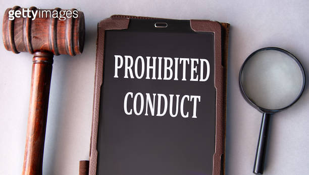 PROHIBITED CONDUCT - words on an electronic notepad with a judge's ...