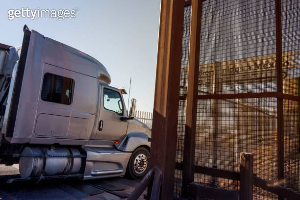 Semi-Truck Passing Through International Border Barrier Between Mexico ...