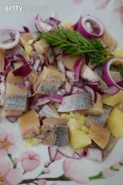 Portioned smoked herring salad with candied lemon and red onions ...