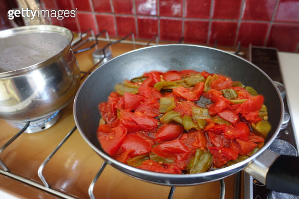Frying red green peppers, tomatoes and garlic Preparation for a savory ...