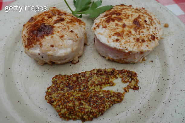 Spicy cooked turkey tournedos served with whole grain mustard 이미지 ...