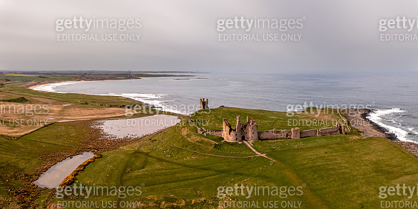 Aerial panorama landscape of the ancient ruins of Dunstanburgh castle ...