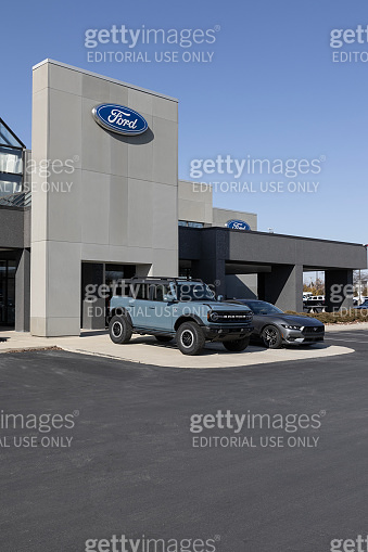 Ford Bronco and Mustang display at a dealership. Ford offers the ...