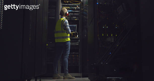 Technician, computer and server room for cables inspection, hardware ...