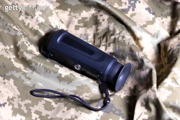 Thermal imaging army sight on the khaki camouflage uniform. Black ...