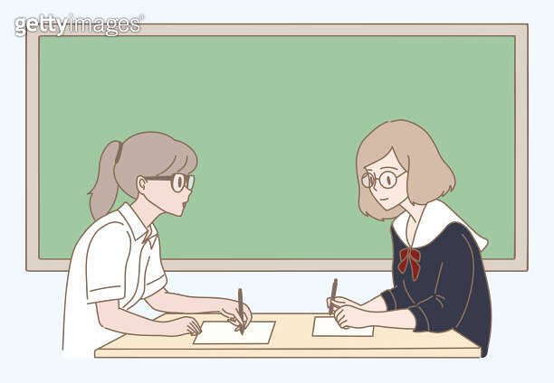 Young school student studying with teacher, Classmate explaining lesson ...