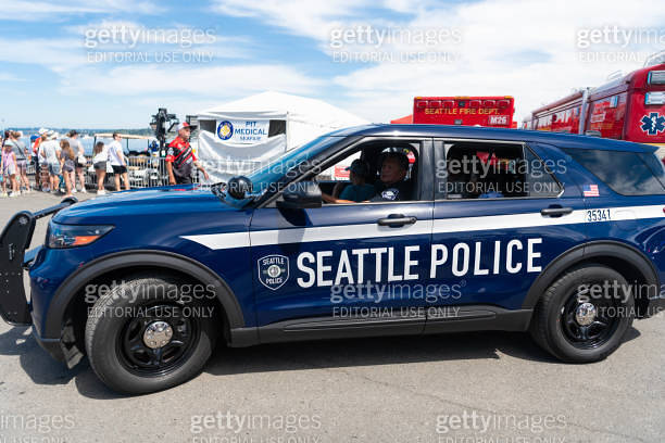 Blue and white Seattle police car parked on street. Seattle state ...