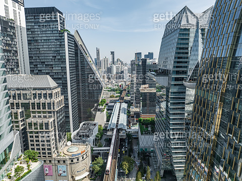 Phloen Chit BTS Skytrain station with high skyscrapers and urban ...