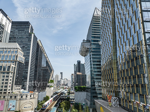 Phloen Chit BTS Skytrain station with high skyscrapers and urban ...