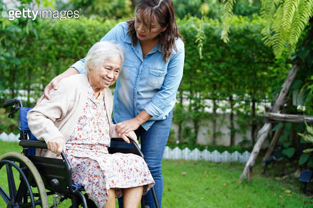 Caregiver help Asian elderly woman disability patient sitting on ...