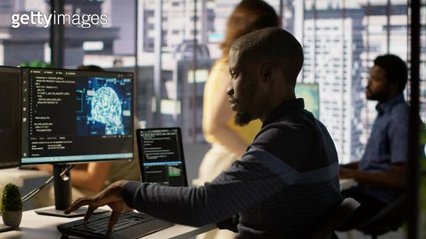 Man programming in office using artificial intelligence tech ...