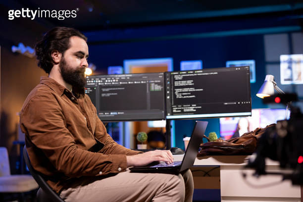 Programmer doing software debugging using laptop, checking errors in ...