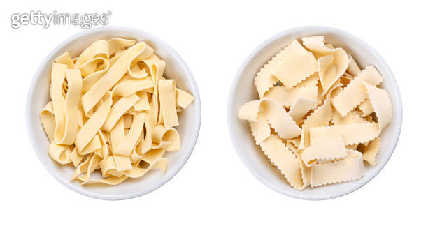 Two types of short thick ribbon pasta, uncooked Italian laminated pasta ...
