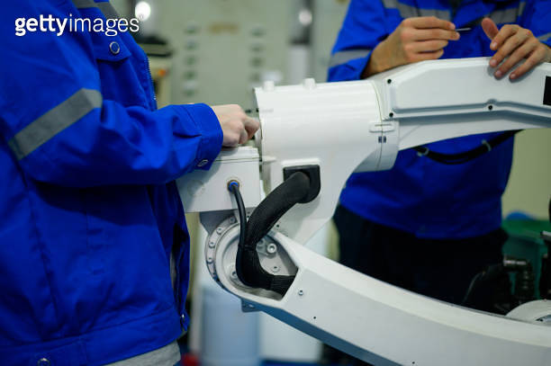 Close up of Robotics engineers Using Controller to Remotely Operate programming and Manipulating ...