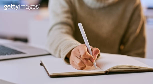 Student, hand and writing in notebook for brainstorming project ideas ...