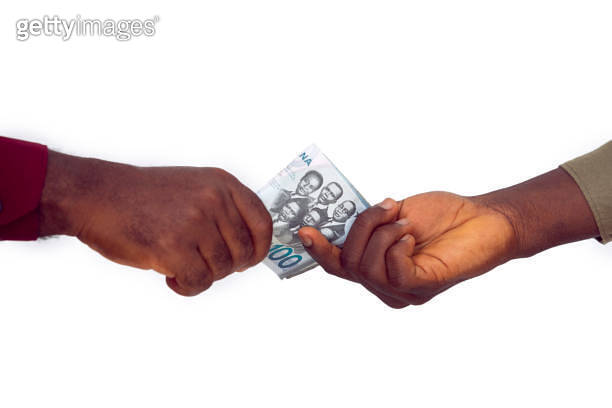 Hand giving Ghanaian cedi notes to another hand. Hand receiving money ...