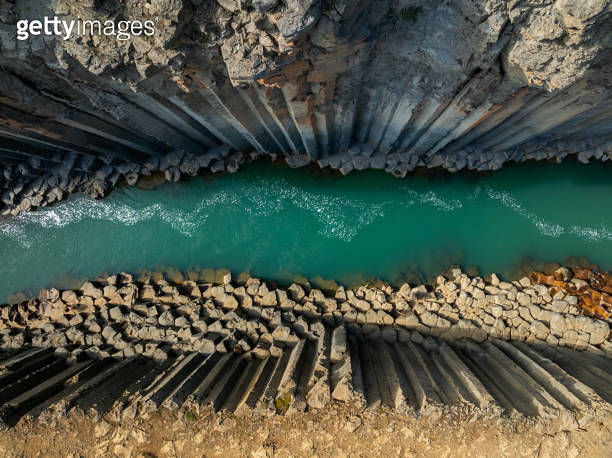 Canyon of basalt columns, cliff with turquoise river, in Iceland ...