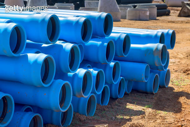 On construction site, there are blue PVC pipes for laying pipe water ...