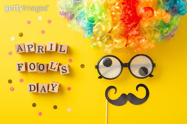Snapshot of wooden letters spelling "April Fool's Day," confetti with ...