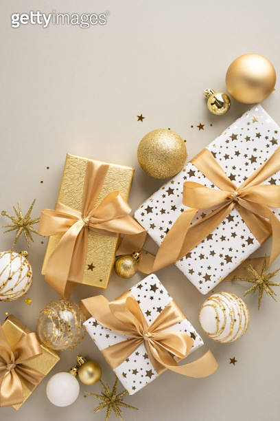A luxurious vertical display of Christmas presents wrapped in gold ...