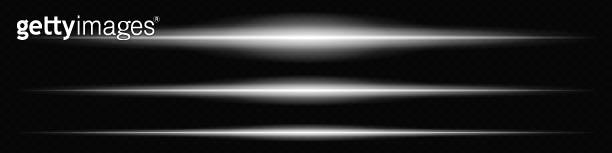 Glowing white laser beam horizontally across a dark transparent ...