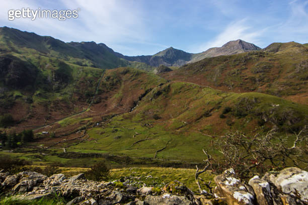 View over the mountains of Eryri National Park, with a valley filled ...