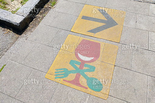 Directional Arrow and Dining Symbol on Paved Sidewalk Urban Navigation ...