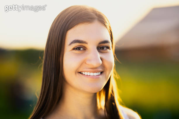 White woman 26 years old closeup portrait in light of setting sun on ...