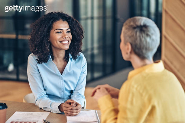 Two business co workers siting talking, discussing important topics ...