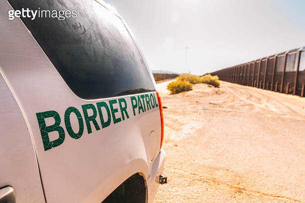 Sun-Baked, Peeling Green "Border Patrol" Text on US Government Border ...