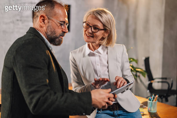 Smart causal mature managers brainstorming and discussing project at ...