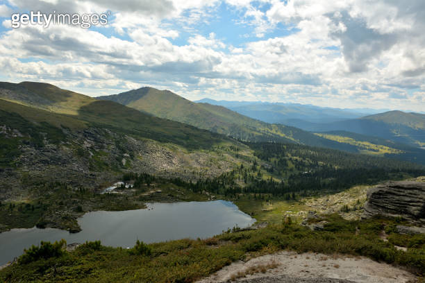 A view from the top to a picturesque lake lying in an intermountain ...