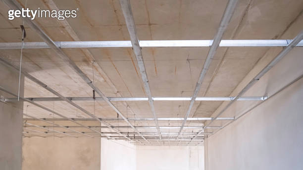 Aluminum c-line ceiling outline on concrete wall over corridor inside ...