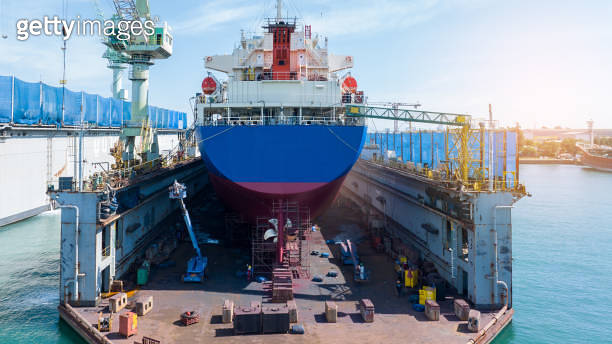 Cargo container ship at dry dock concept maintenance service. working ...