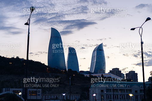 Flame Towers buildings dominating the city skyline on dramatic sunset ...