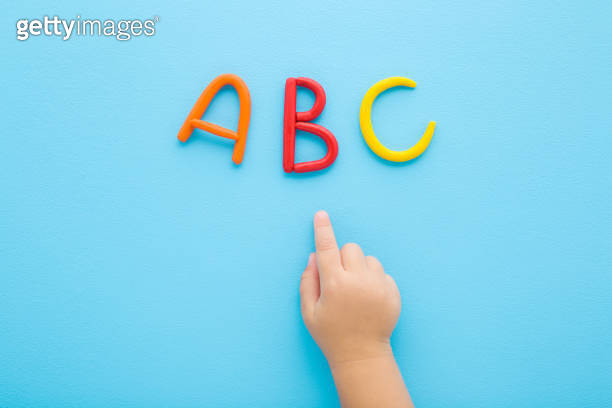 Baby boy hand finger pointing to colorful abc letters created from ...