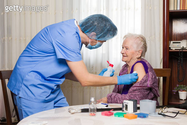 doctor putting ethyl alcohol in a patient's arm for a vaccine injection ...