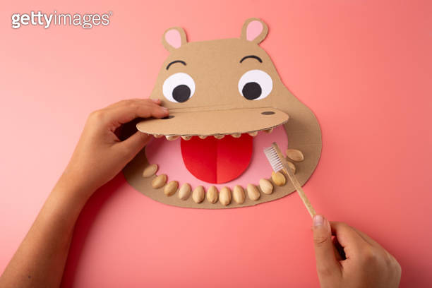 Creative paper craft of a hippo-shaped puppet with a toothbrush ...