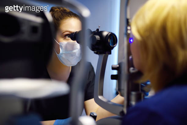 Slit Lamp eye examination with ophthalmologist. Patient during visit by ...