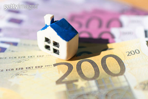 Miniature toy house placed on Euro bill banknotes. Concept for real ...